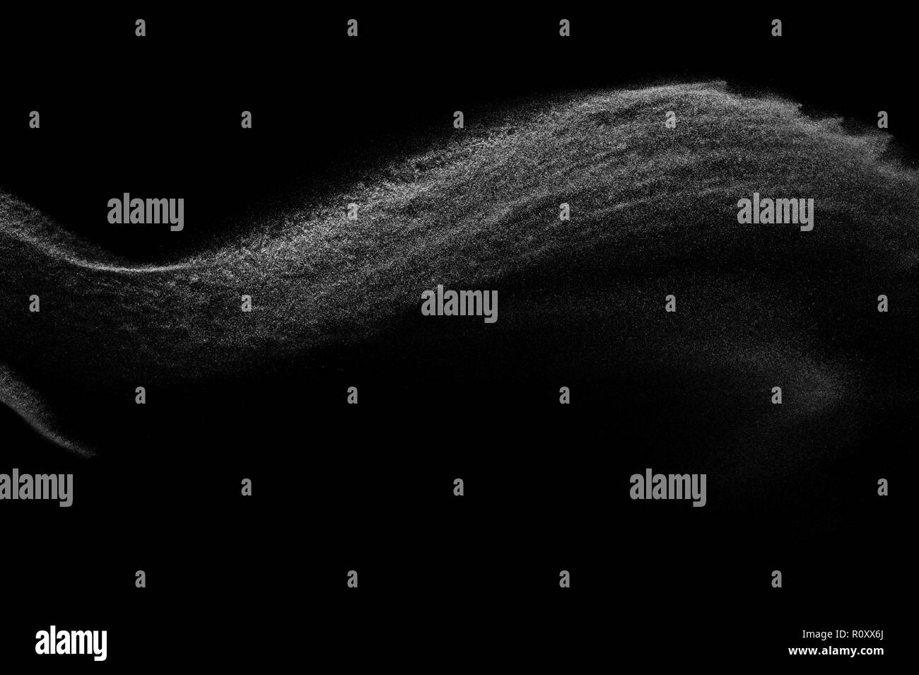 Freeze motion of white particles on black background. Powder explosion ...