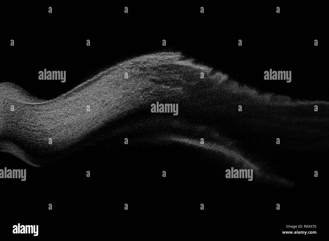 Freeze motion of white particles on black background. Powder explosion ...