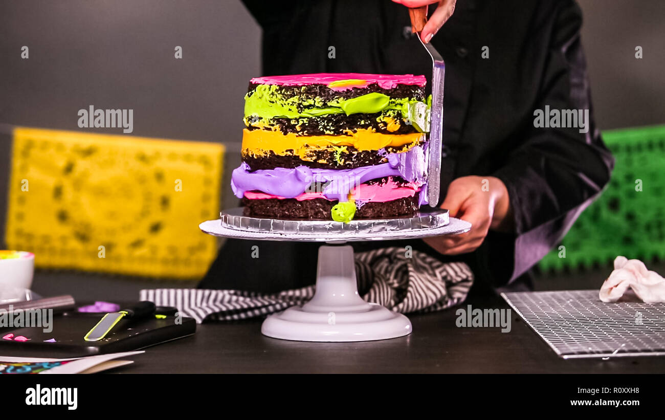 Step by step. Baker frosting multilayer chocolate cake with buttercream ...