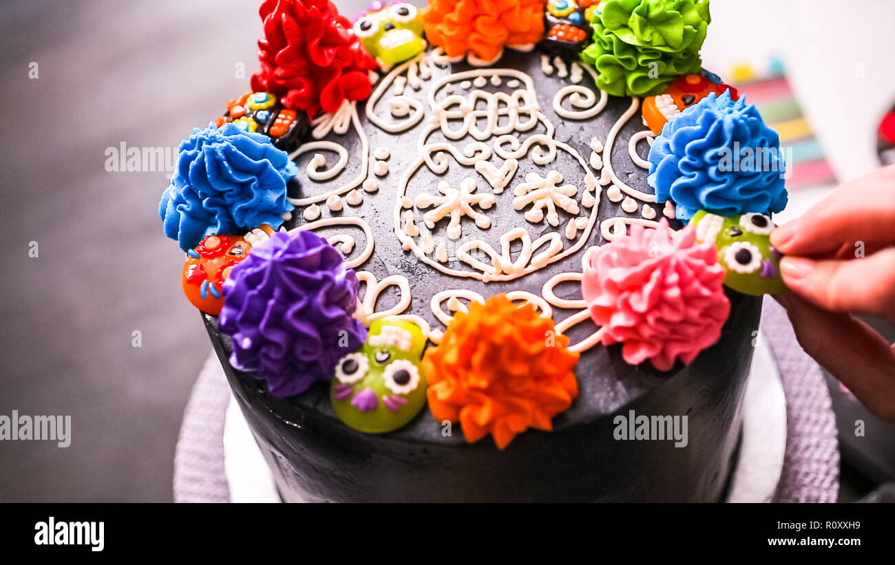 Step by step. Baker piping colorful buttercreal italian icing on a top ...