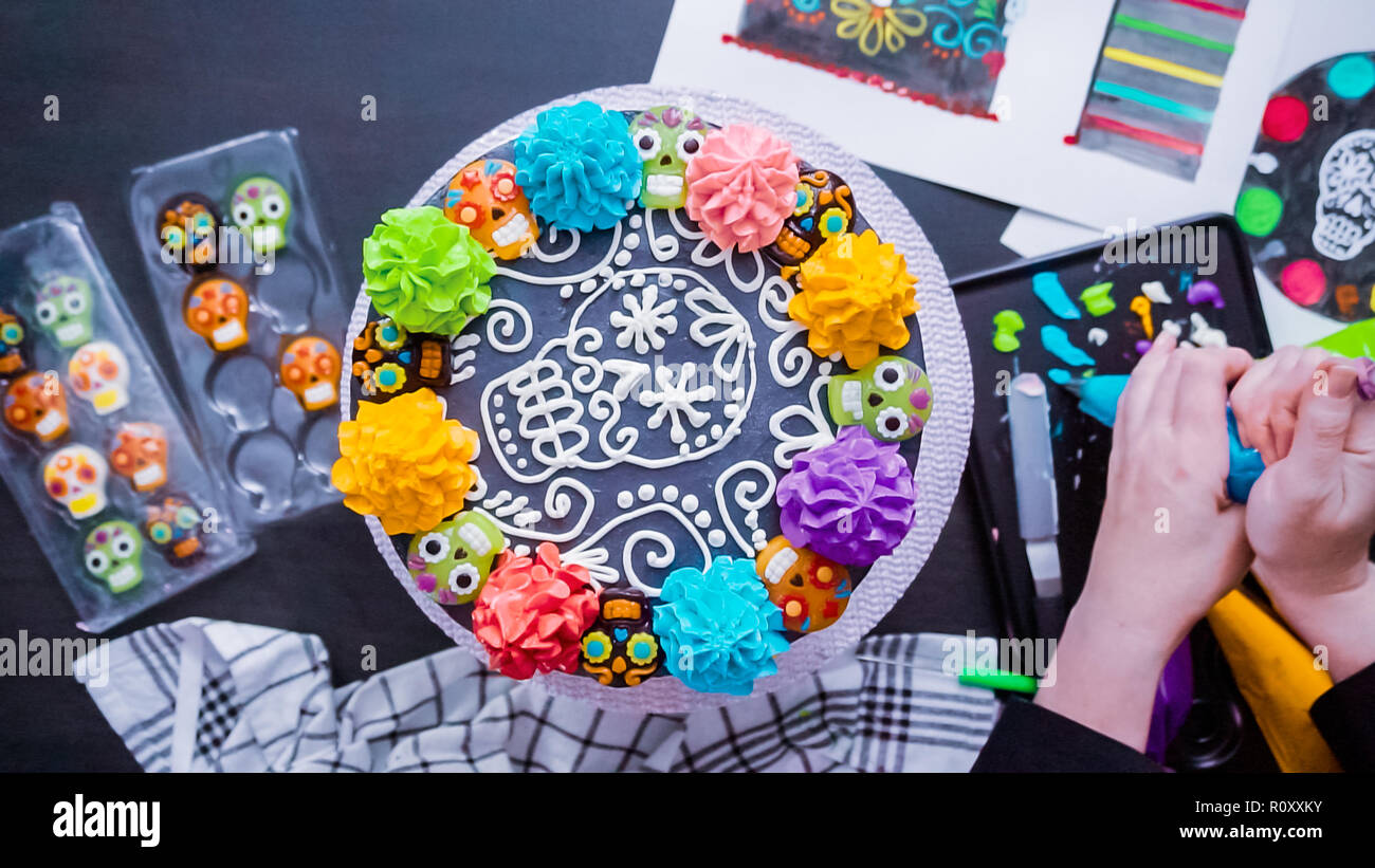 Step by step. Flat lay. Baker decorating multilayer chocolate cake with ...