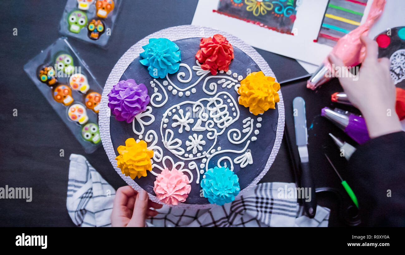 Step by step. Flat lay. Baker piping colorful buttercreal italian icing ...