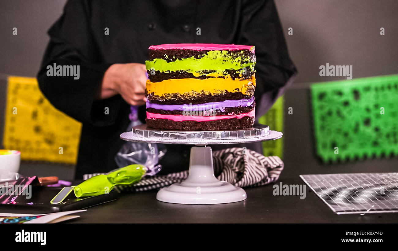Step by step. Baker frosting multilayer chocolate cake with buttercream ...