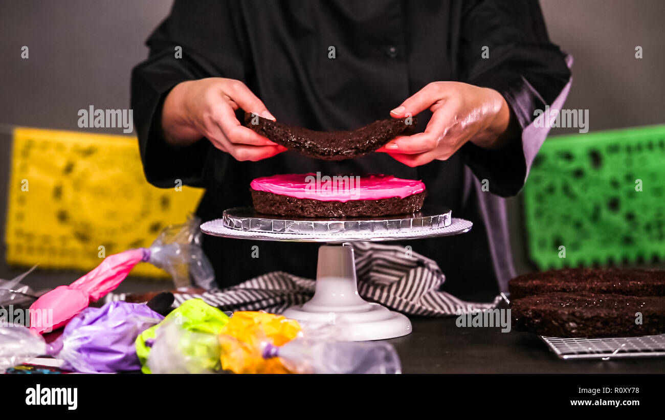 Step by step. Baker assembling a chocolate cake with bright colorful ...