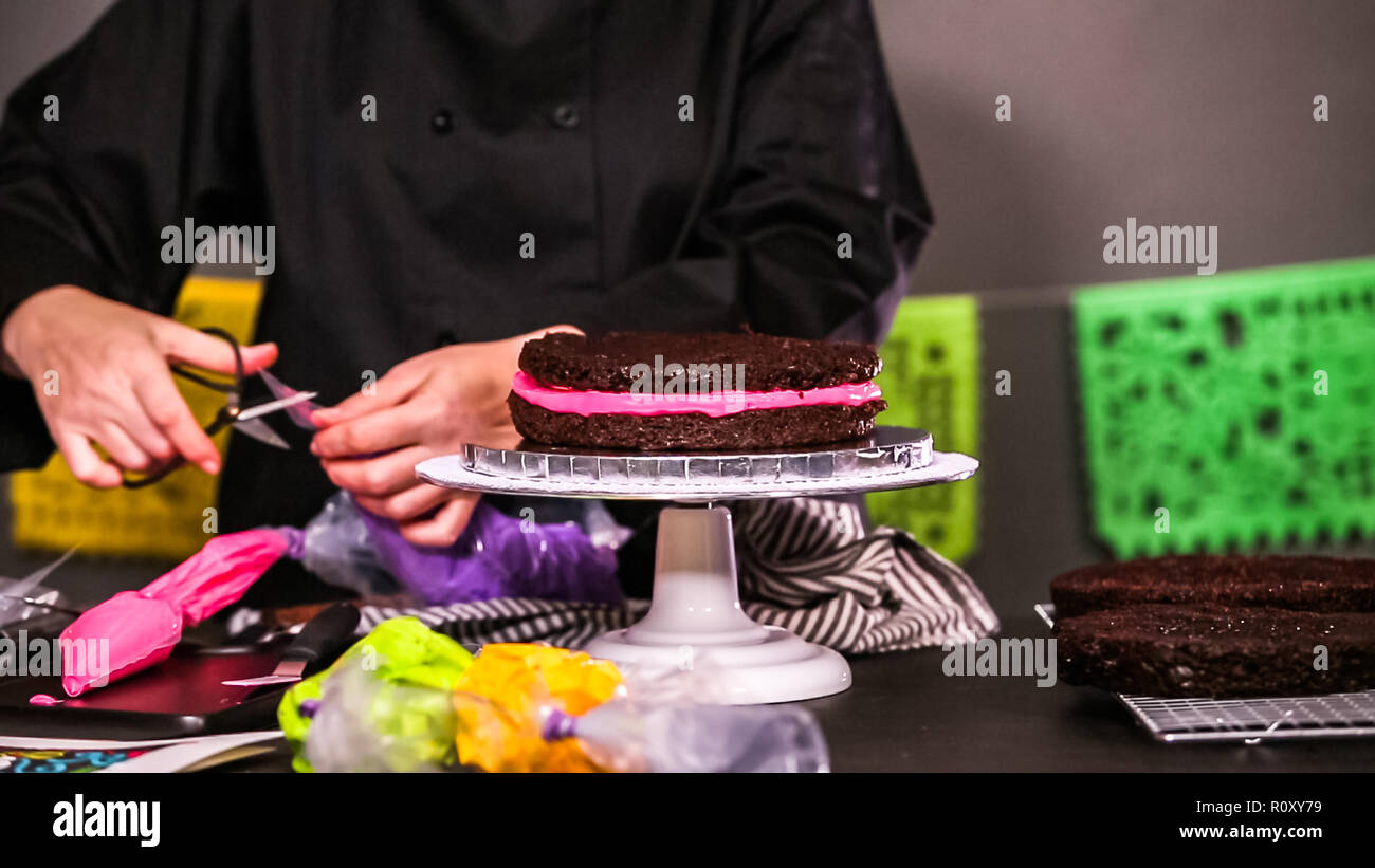 Step by step. Baker assembling a chocolate cake with bright colorful ...