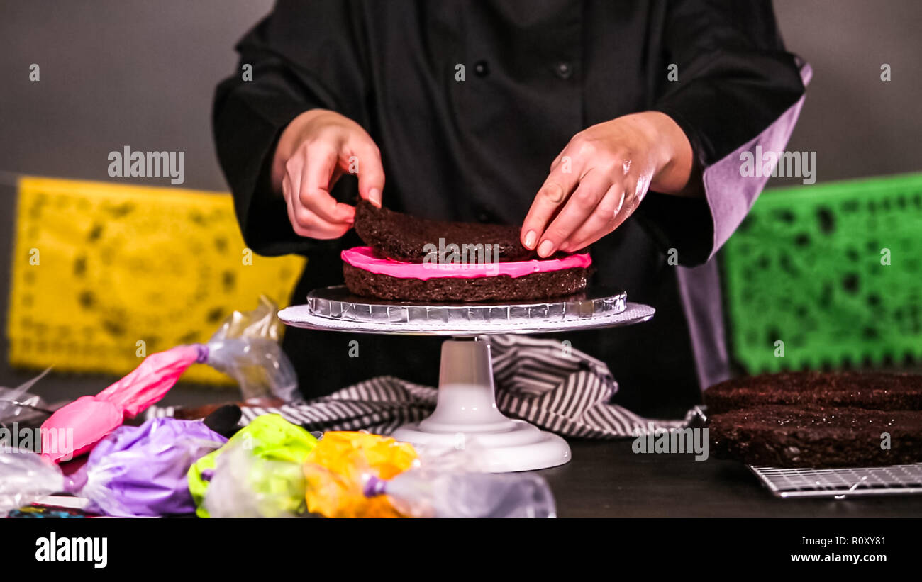 Step by step. Baker assembling a chocolate cake with bright colorful ...