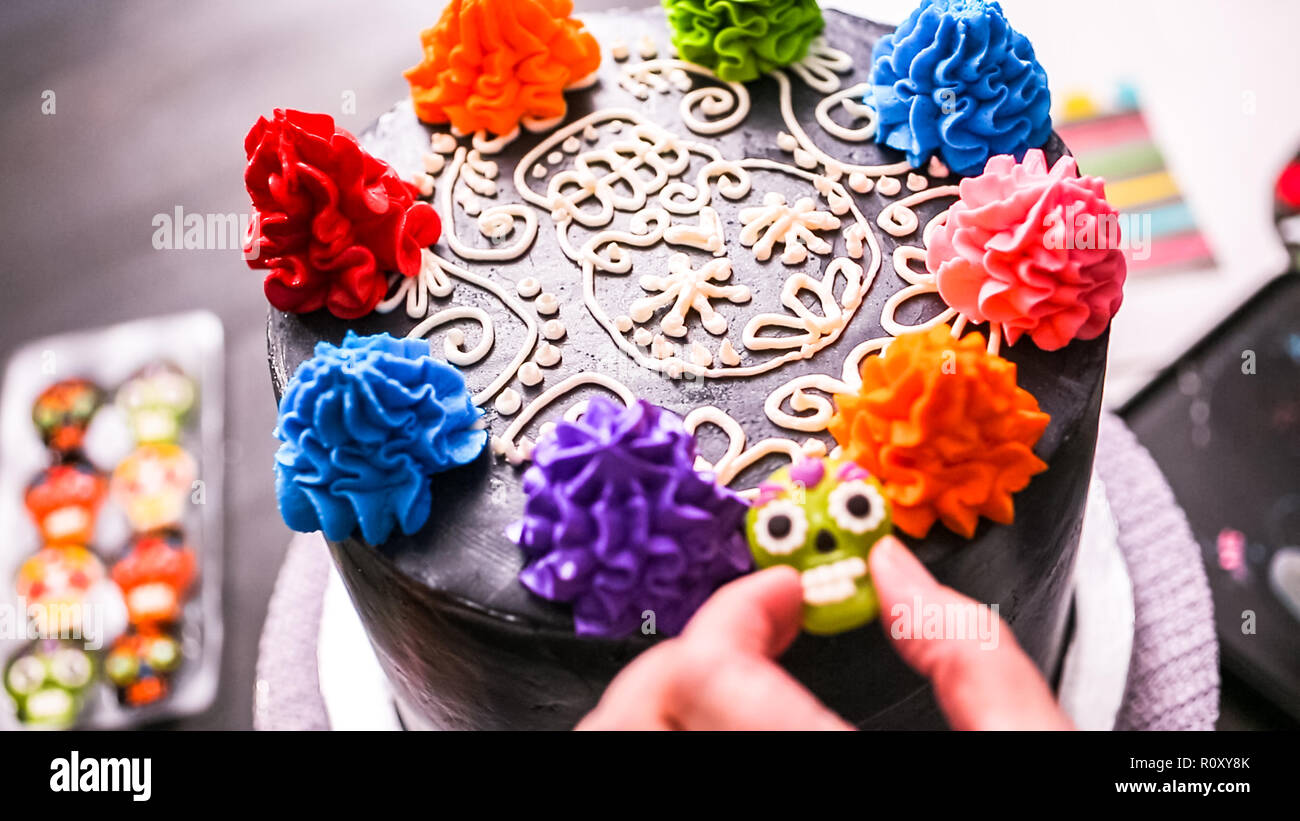 Step by step. Baker piping colorful buttercreal italian icing on a top ...