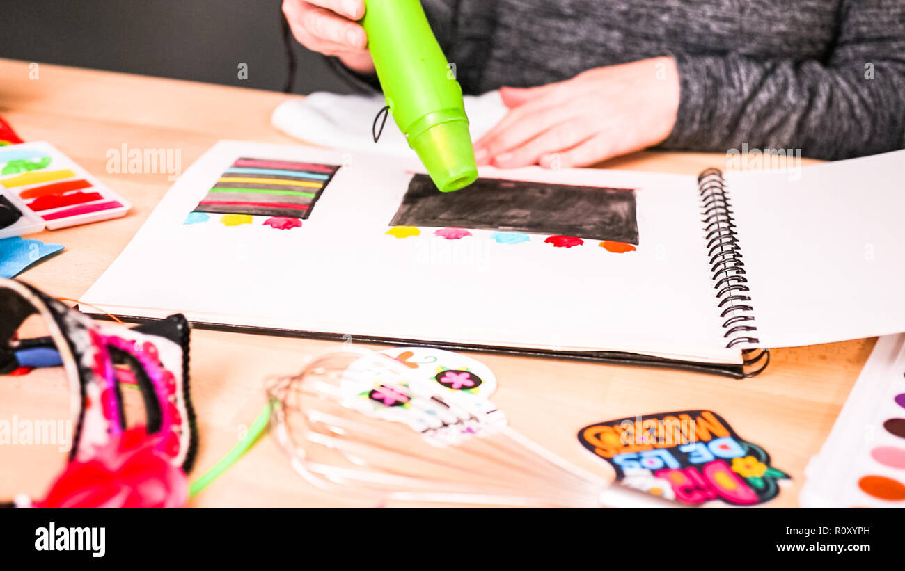 Step by step. Baker drying a watercolor sketch of a cake with heat gun ...