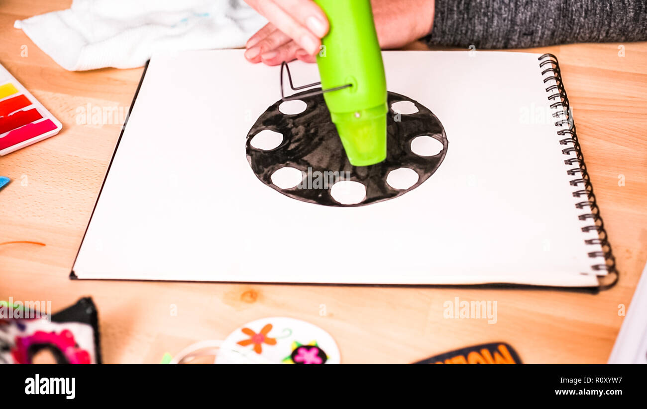Step by step. Baker drying a watercolor sketch of a cake with heat gun ...