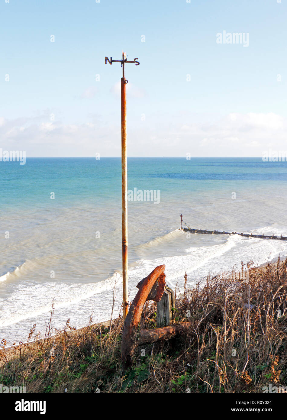 A view of the sea with an old ships anchor and broken weather vane from ...