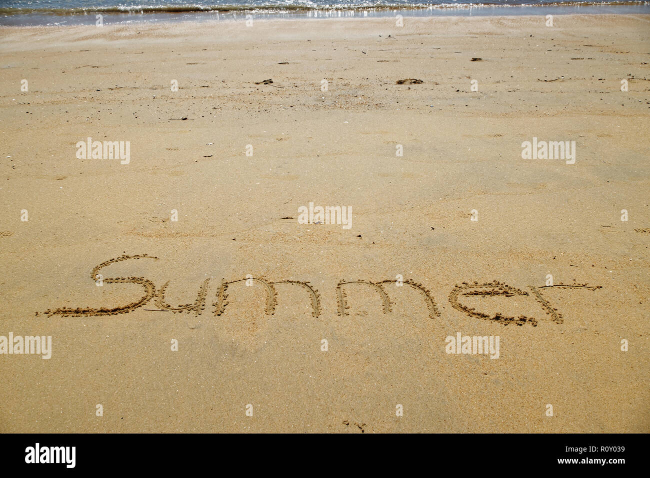 Hand written message saying Summer on the beach Stock Photo - Alamy
