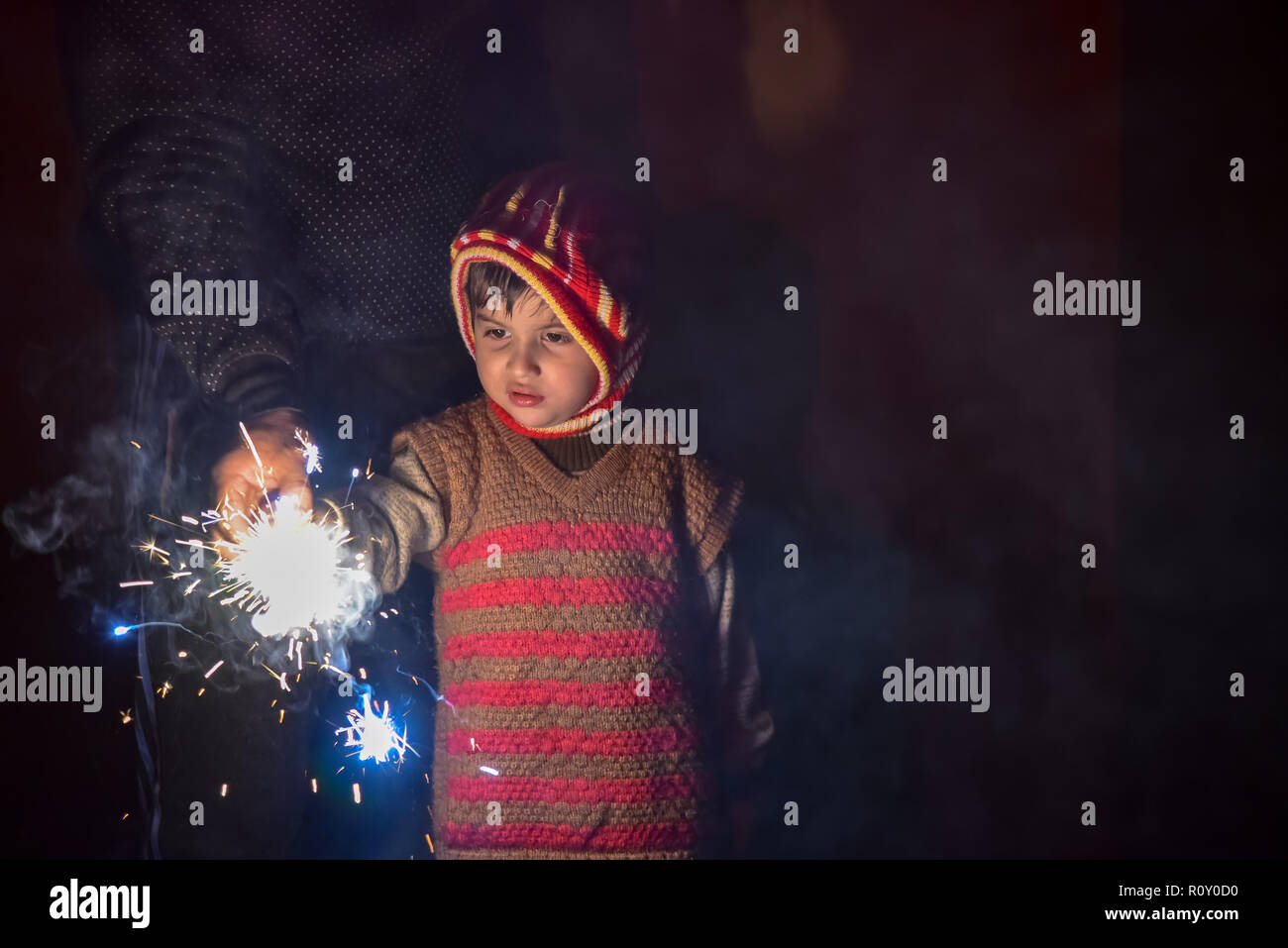 Kashmiri Hindu child light firecrackers during Diwali Festival ...