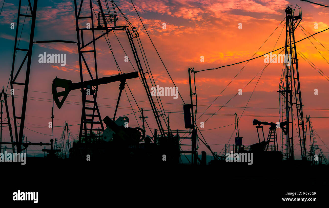 Oil rigs at sunset, industrial background Stock Photo - Alamy