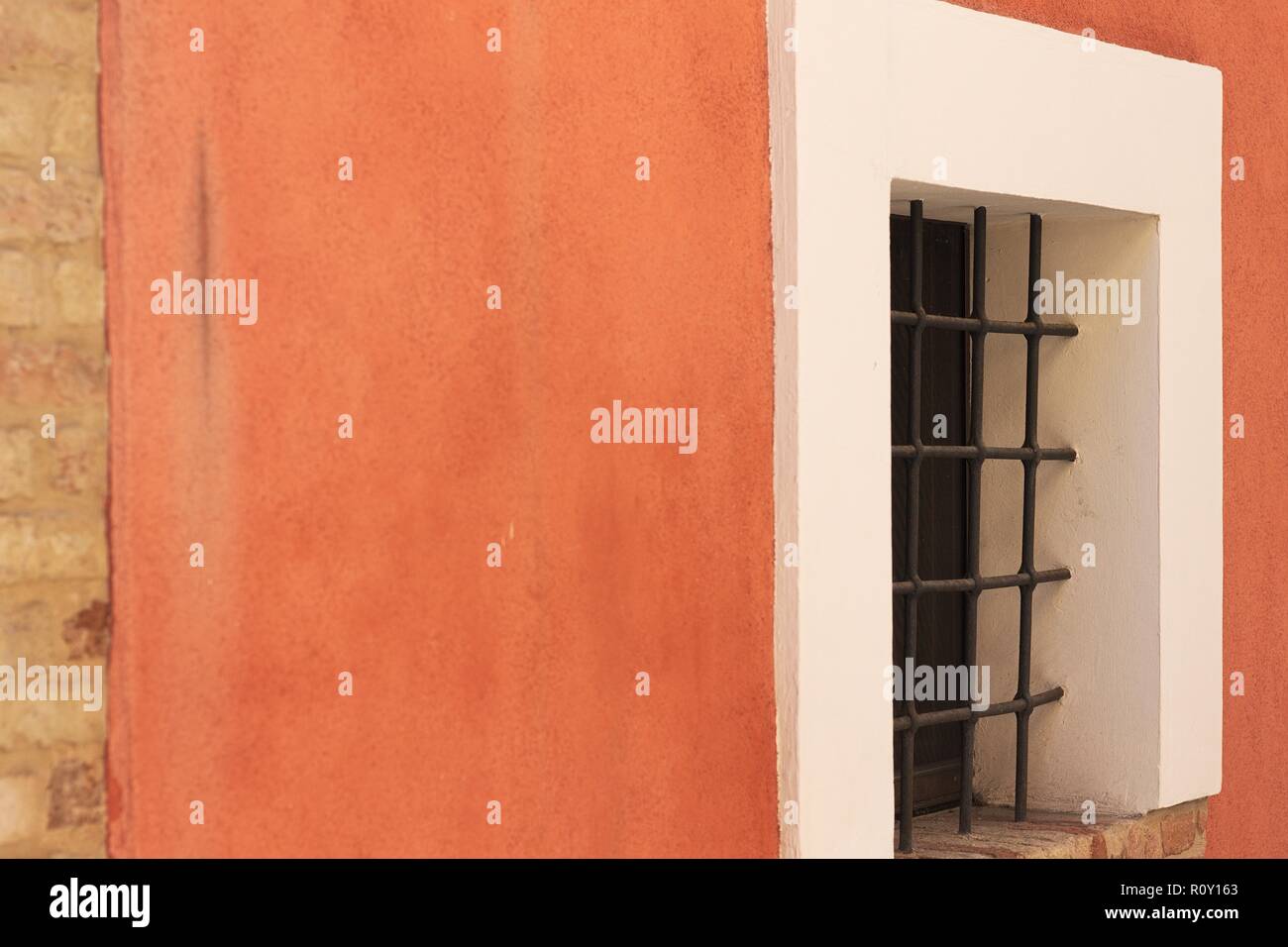 Isolated window with gratings in an orange wall (Tolentino, Italy Stock ...