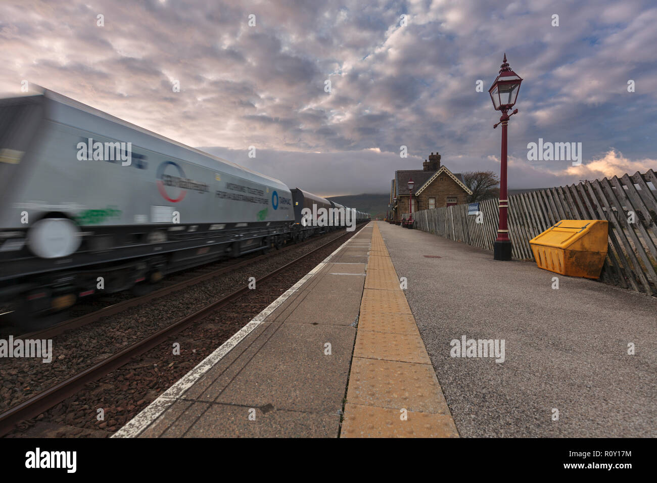 A GB Railfreight operated stone freight train passing Ribblehead ...