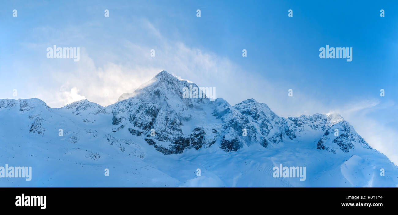 Panorama of beautiful windy weather over high alpine mountain range ...