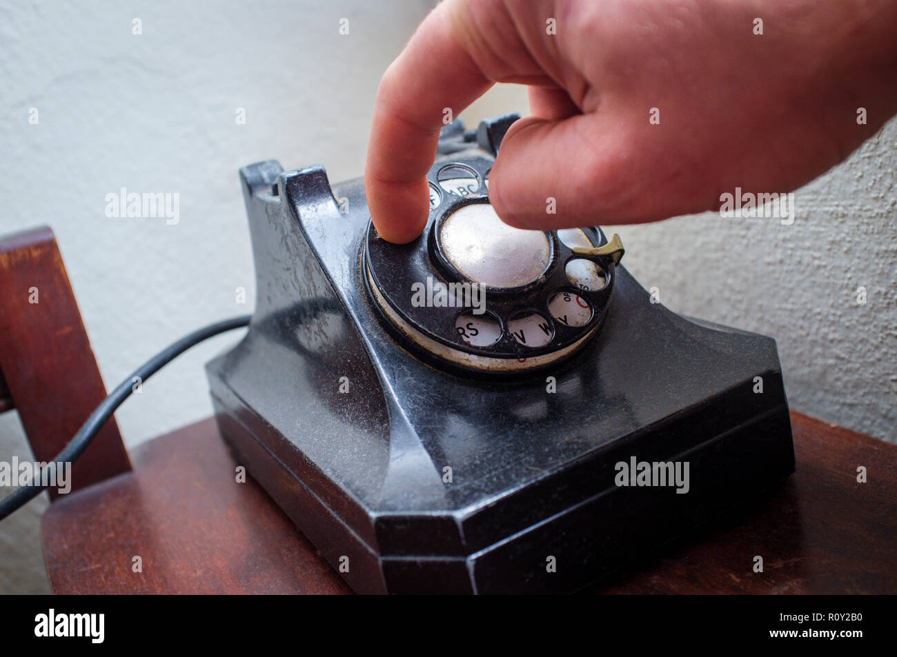 Old vintage rotary dial telephone on wooden desk Stock Photo - Alamy