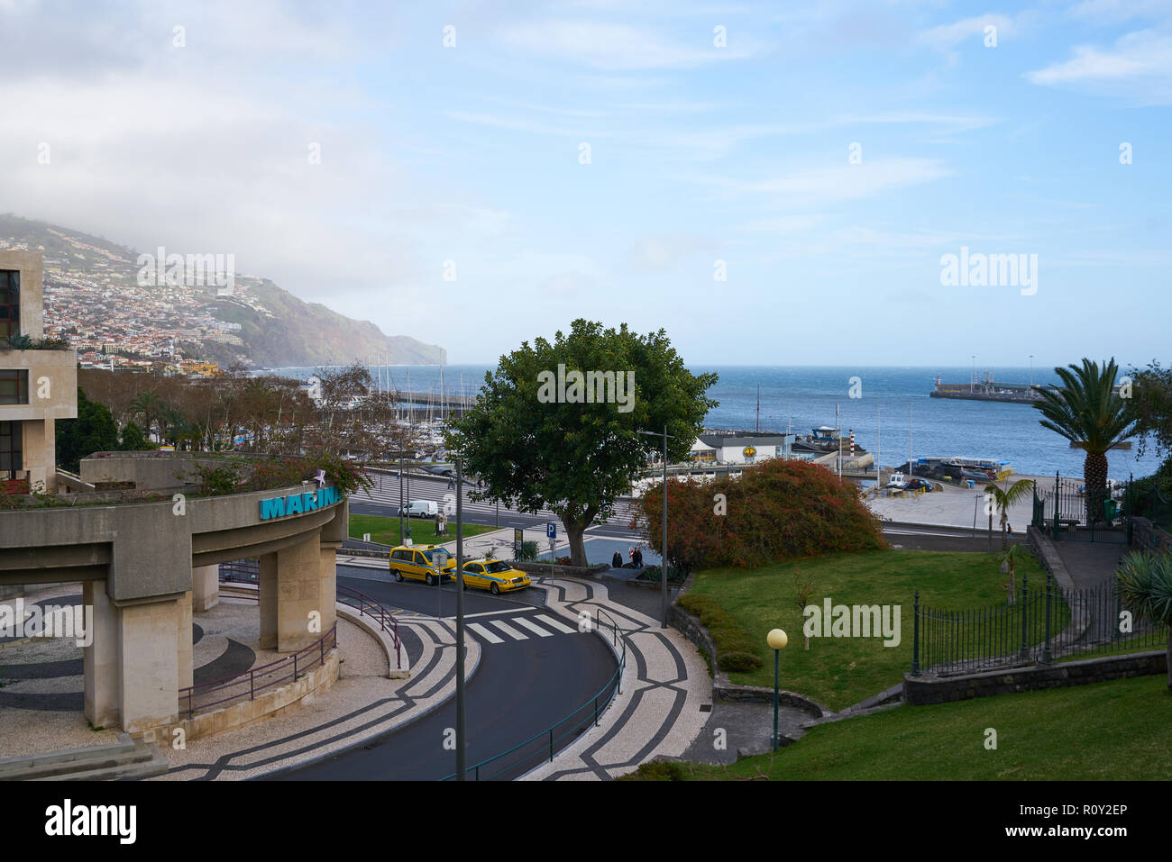 View of marina in Funchal Madeira with iconic building and mountains in ...