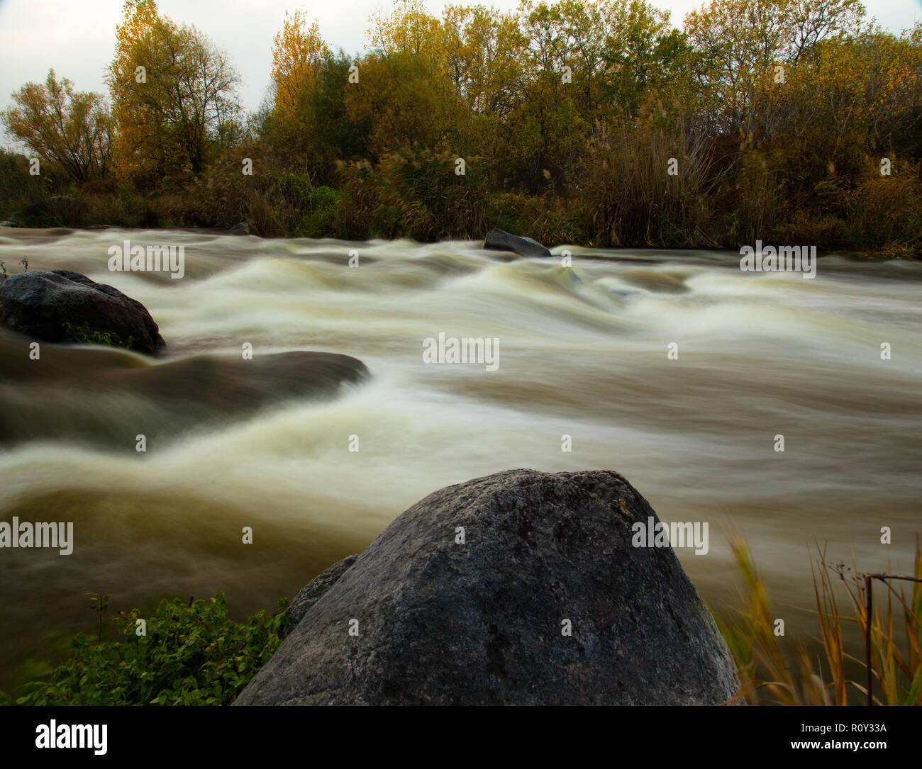 game of colors and shades of the mountain river flow around the rapids ...
