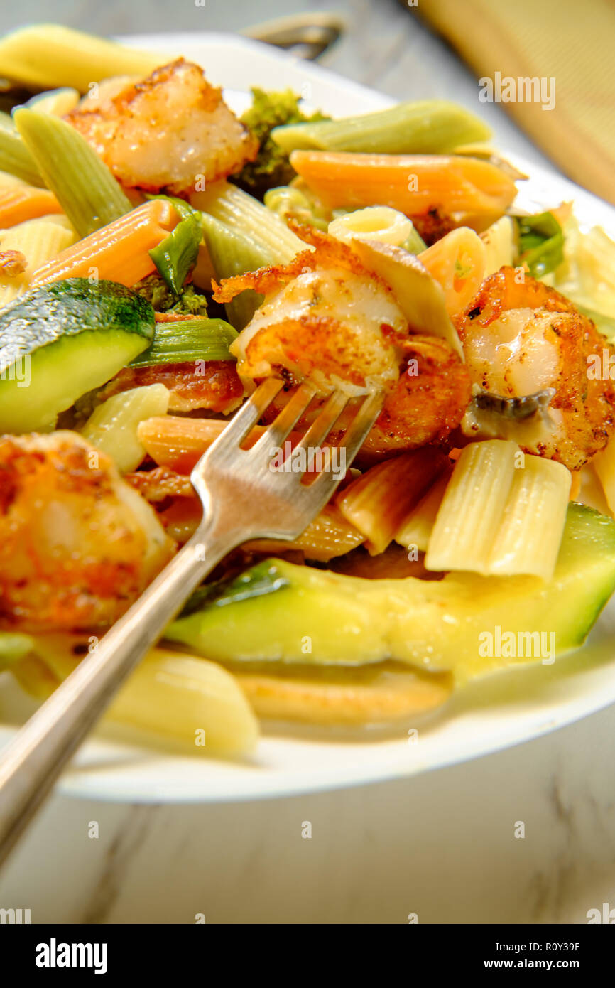 Shrimp primavera with tricolor penne in a white wine sauce Stock Photo ...