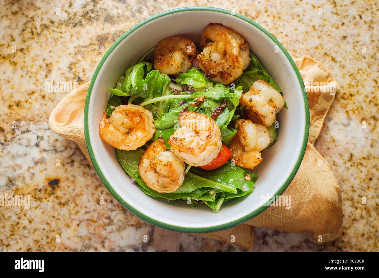 Spring mix shrimp salad in bowl with marble kitchen table Stock Photo ...