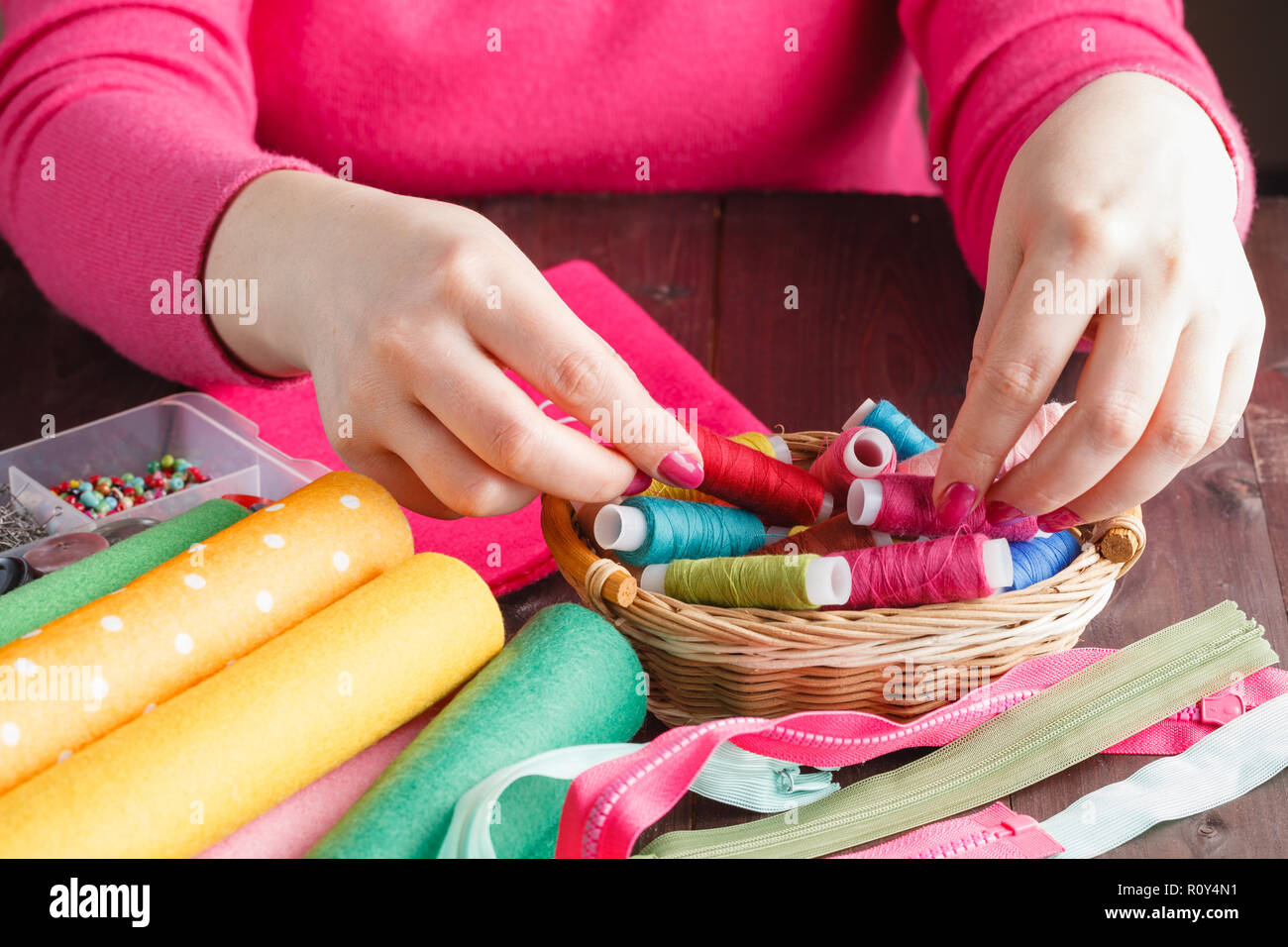 Woman threads a needle hi-res stock photography and images - Alamy