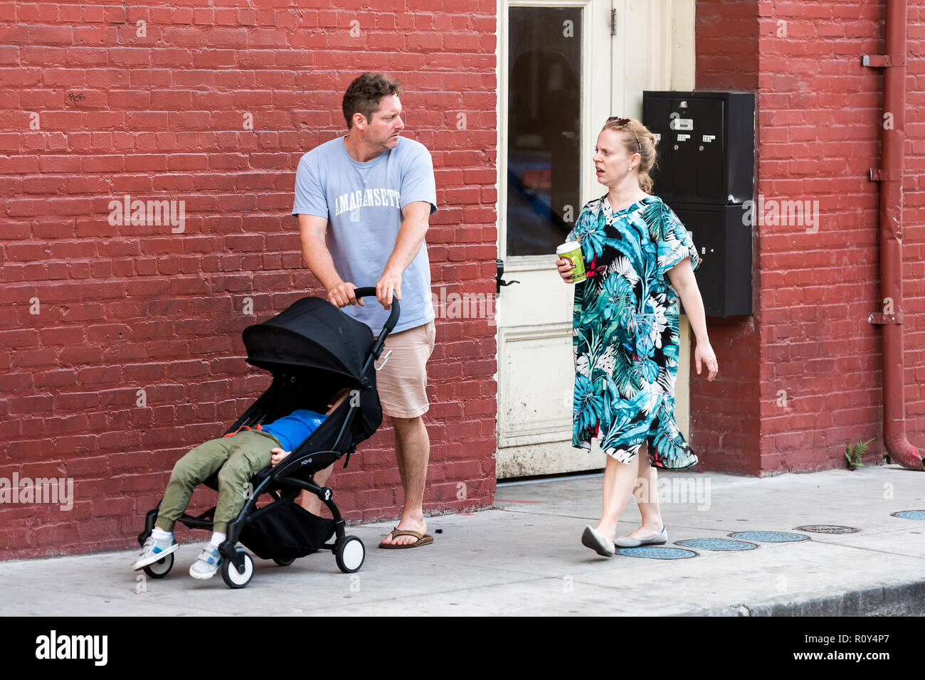 Man and woman pushing stroller hi-res stock photography and images - Alamy