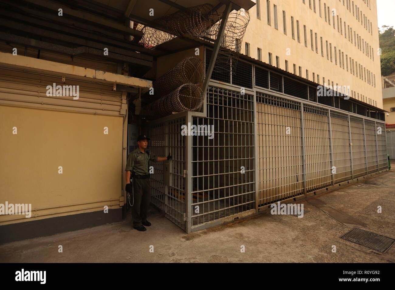 Hong Kong, CHINA. 8th Nov, 2018. A warden guarding a barred gate inside ...