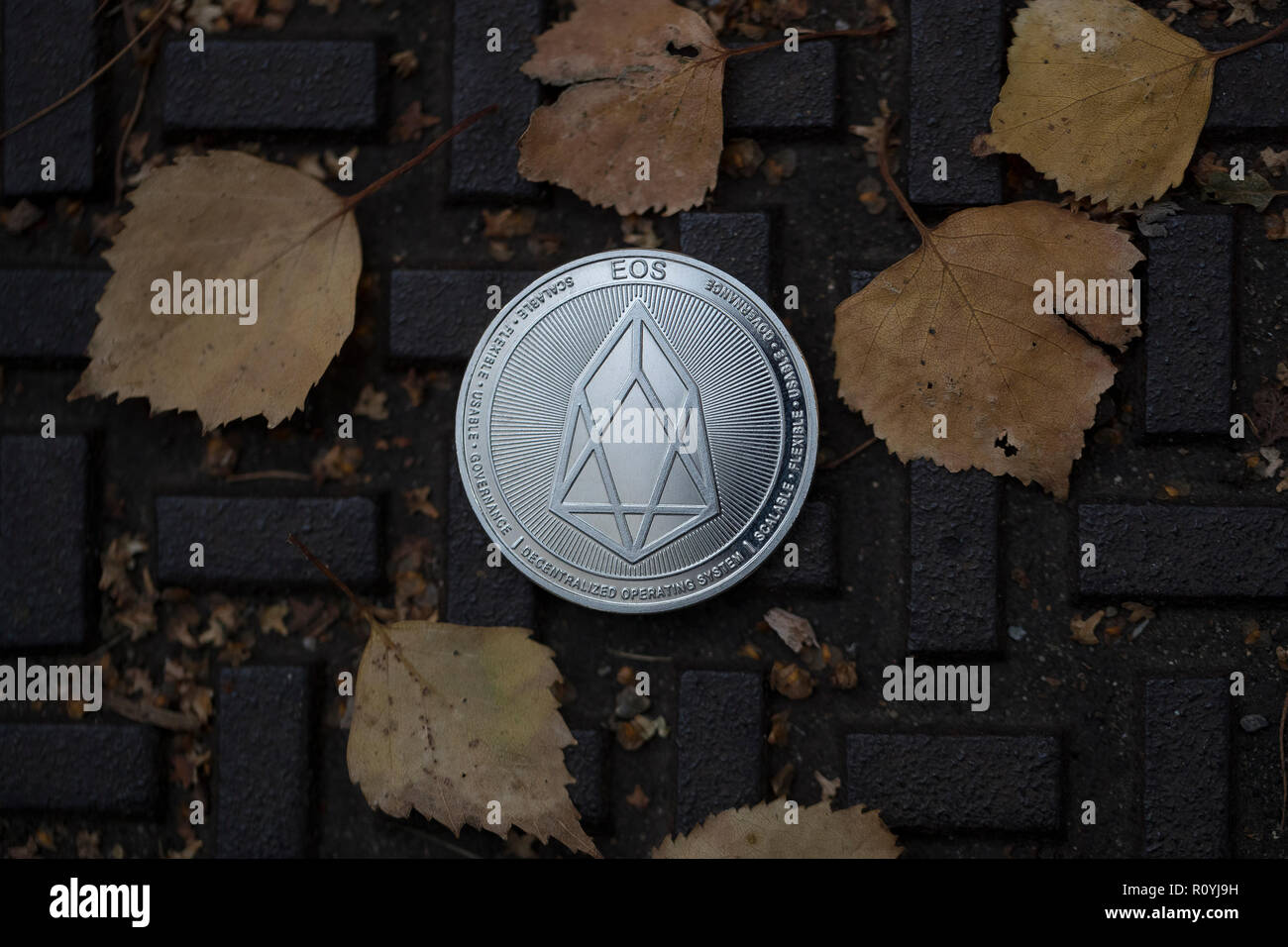 Eos cryptocurrency physical coin placed on the metal surface of the ...