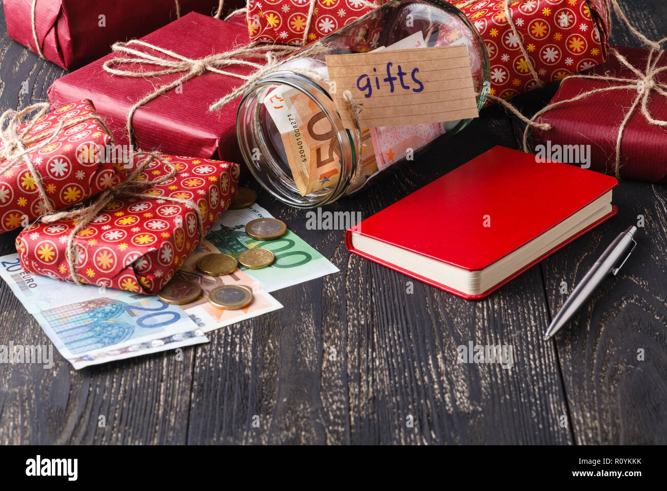 Save money for gift concept, open glass jar with banknotes Stock Photo ...