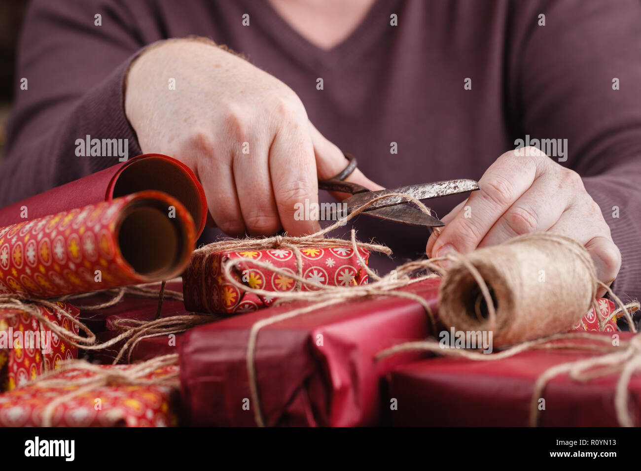 man wraps gifts for christmas or a birthday Stock Photo - Alamy