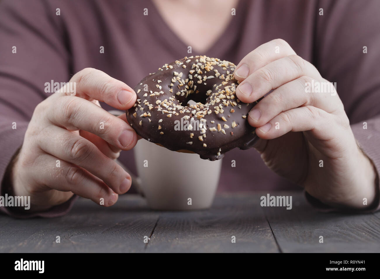man eating chocolate donut Stock Photo - Alamy