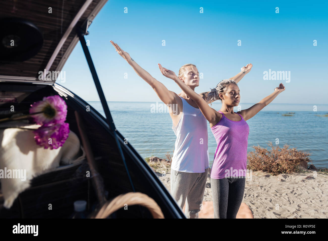 Healthy couple improving their flexibility while meditating together ...