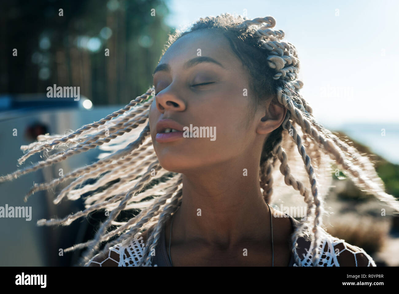 Close up woman with dreadlocks feeling free and relaxed in nature Stock ...