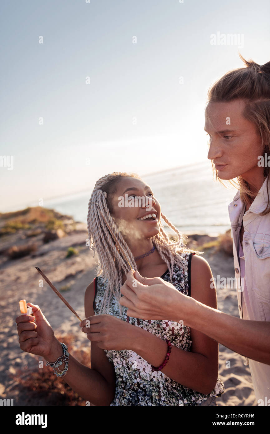Cheerful woman with dreadlocks feeling excited before lightening ...
