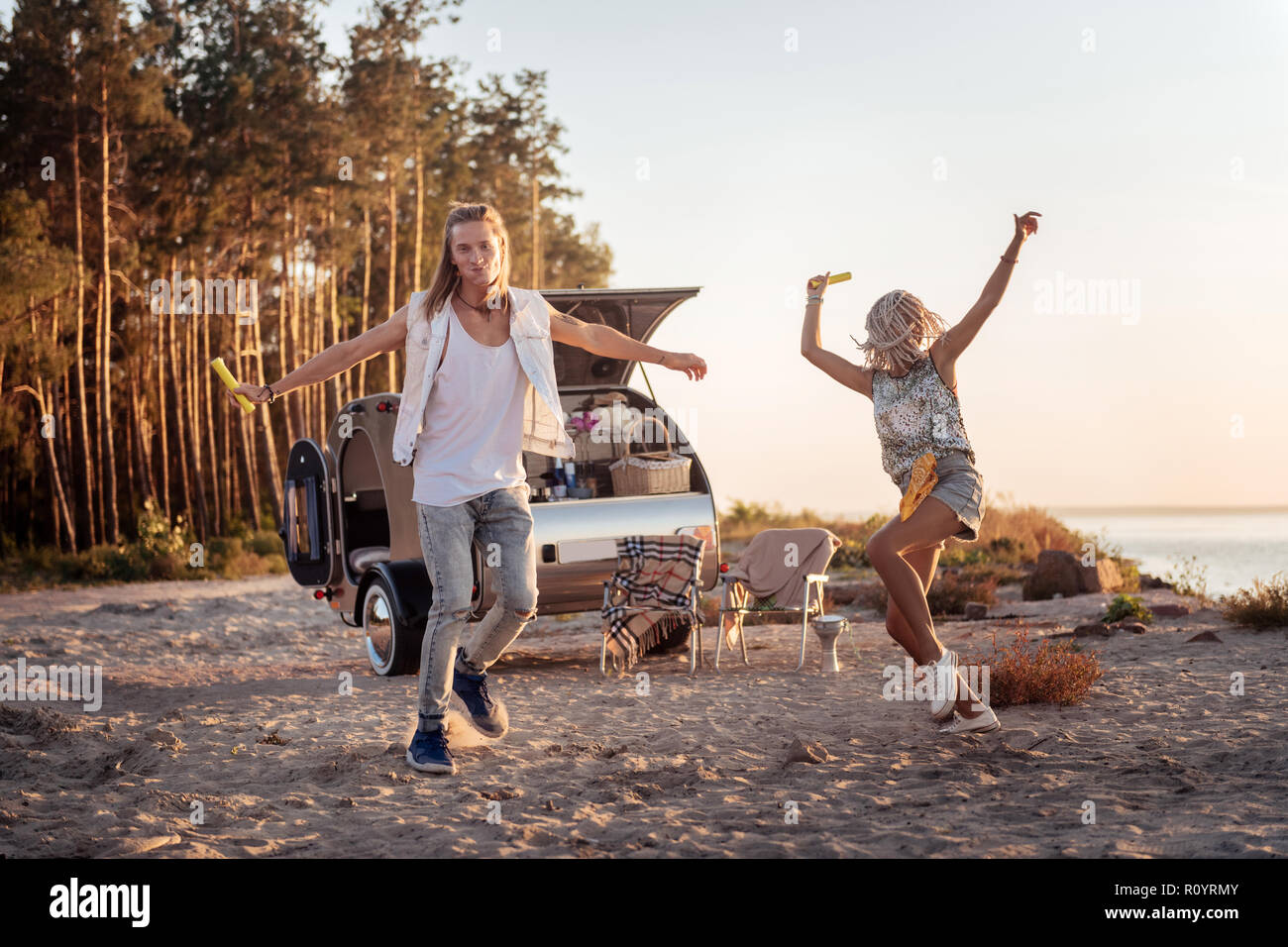 Crazy active couple hanging out near their mobile home feeling amazing ...