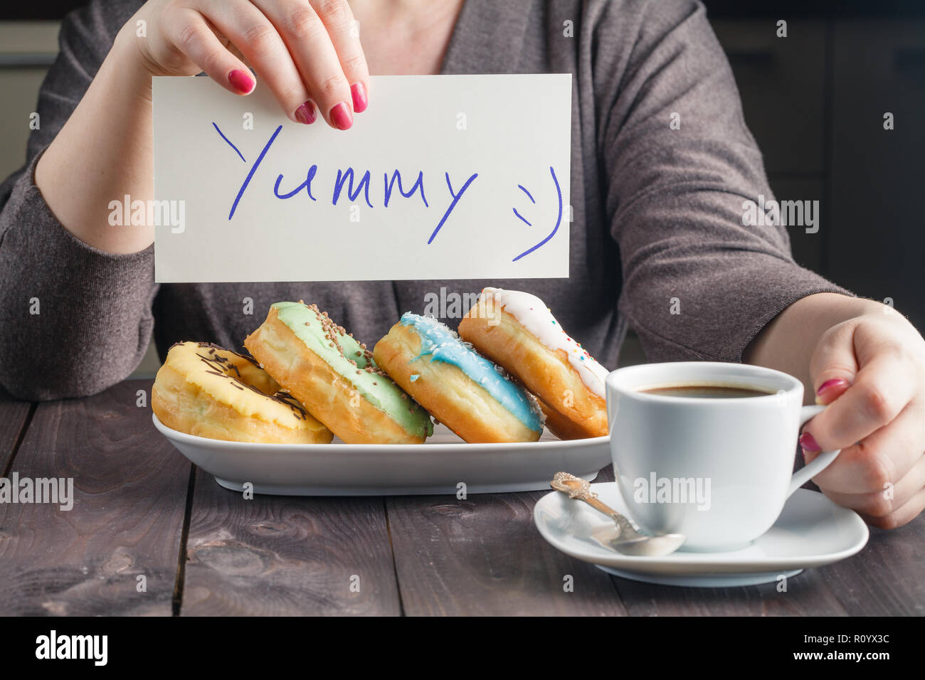 Yummy donuts. Woman hold message about donuts Stock Photo - Alamy