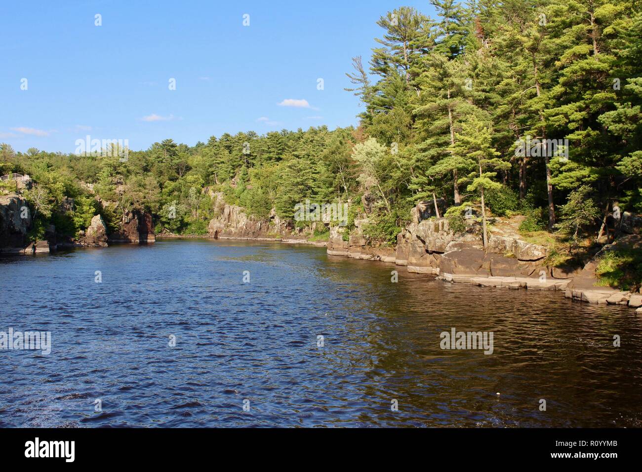 Large scenic river with beautiful glacier-carved rocky cliff formations ...
