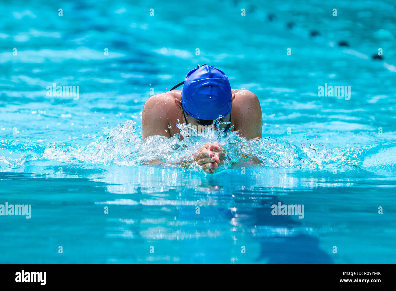 Male swimmer working on his breaststroke swimming at a local pool on a ...