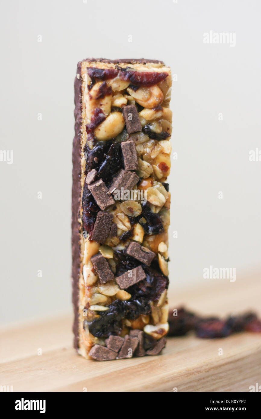 Healthy, natural granola bar with oats, nuts, and fruit sitting wooden ...