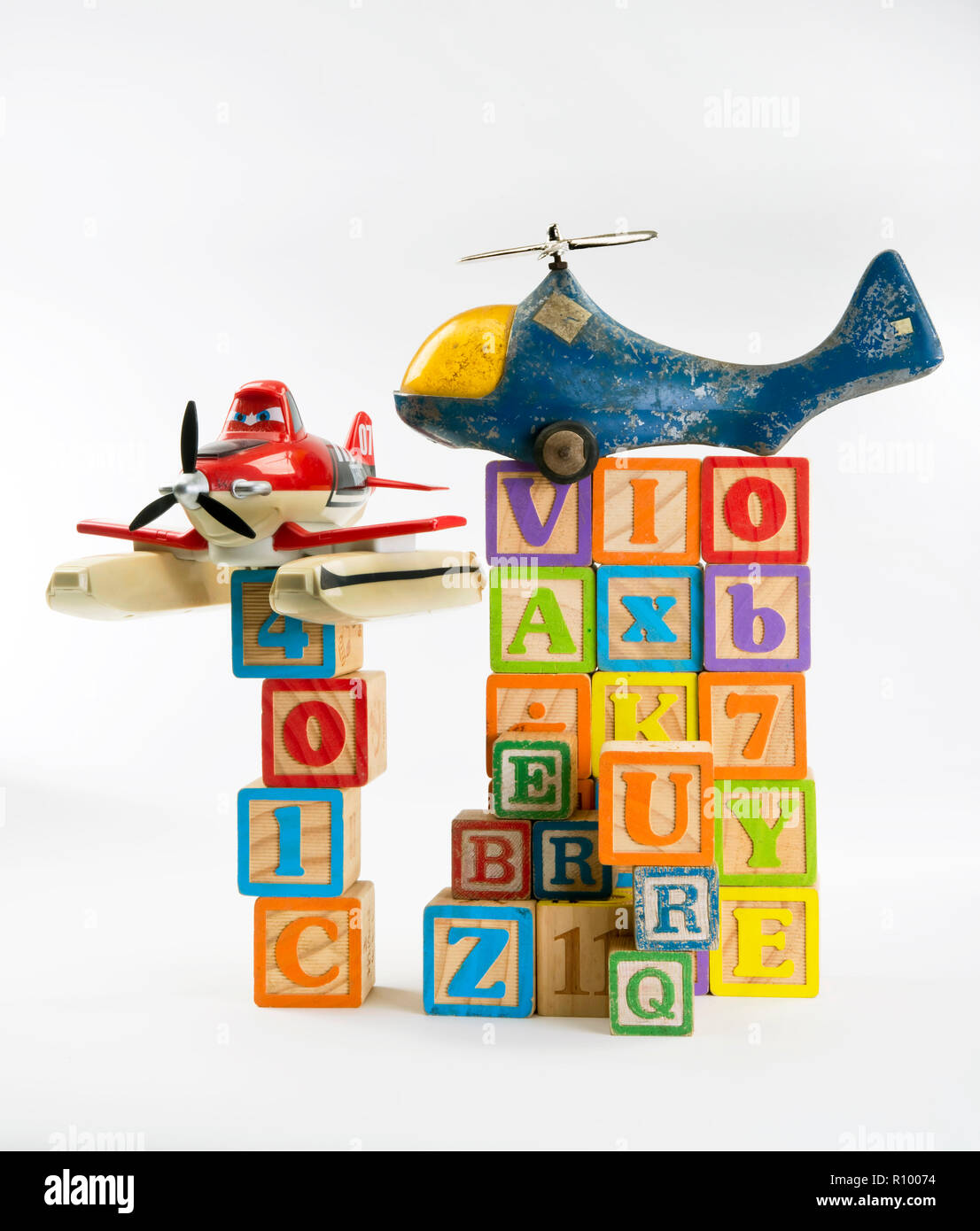 Toy letter blocks ,planes and a toy helicopter Stock Photo - Alamy