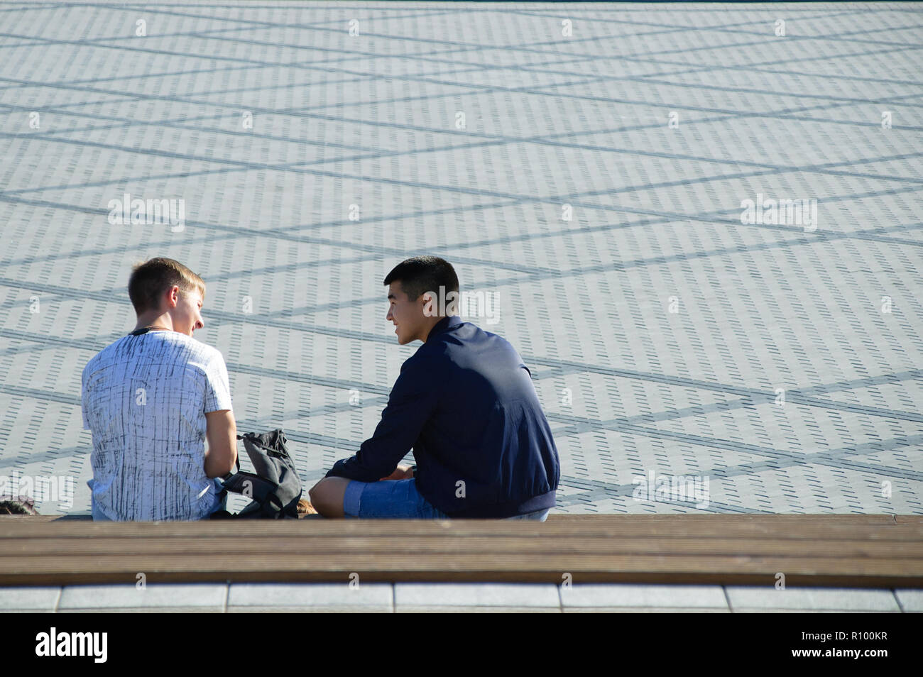 Two guys sitting on bench hi-res stock photography and images - Alamy