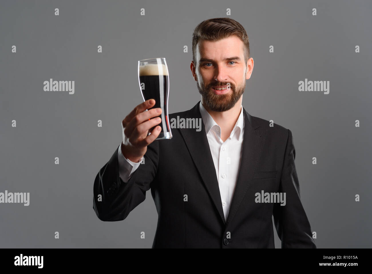 Guy showing glass of beer Stock Photo - Alamy