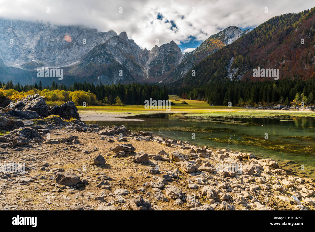 Fiery autumn. Reflections on the upper lake of Fusine. Friuli Stock ...