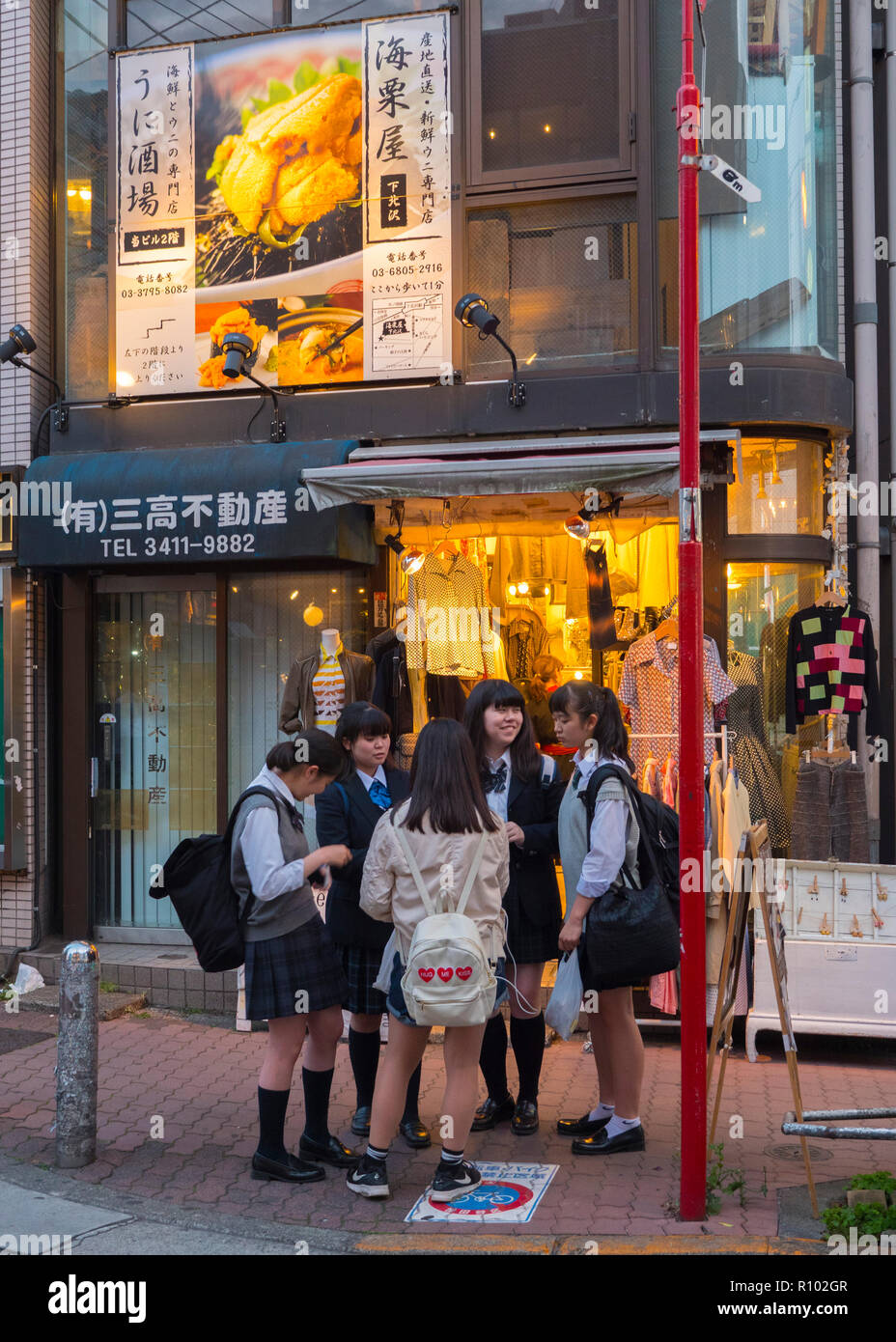 School girls talk in the narrow streets of Shimo-Kitzawa in Tokyo ...