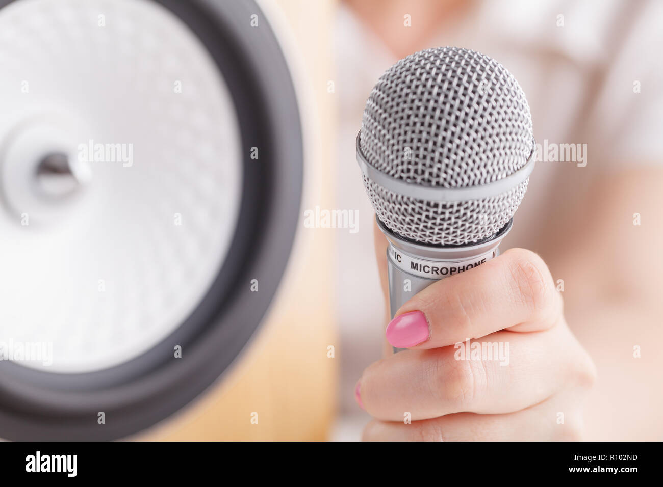 Selective focus photo of microphone in human hand Stock Photo - Alamy