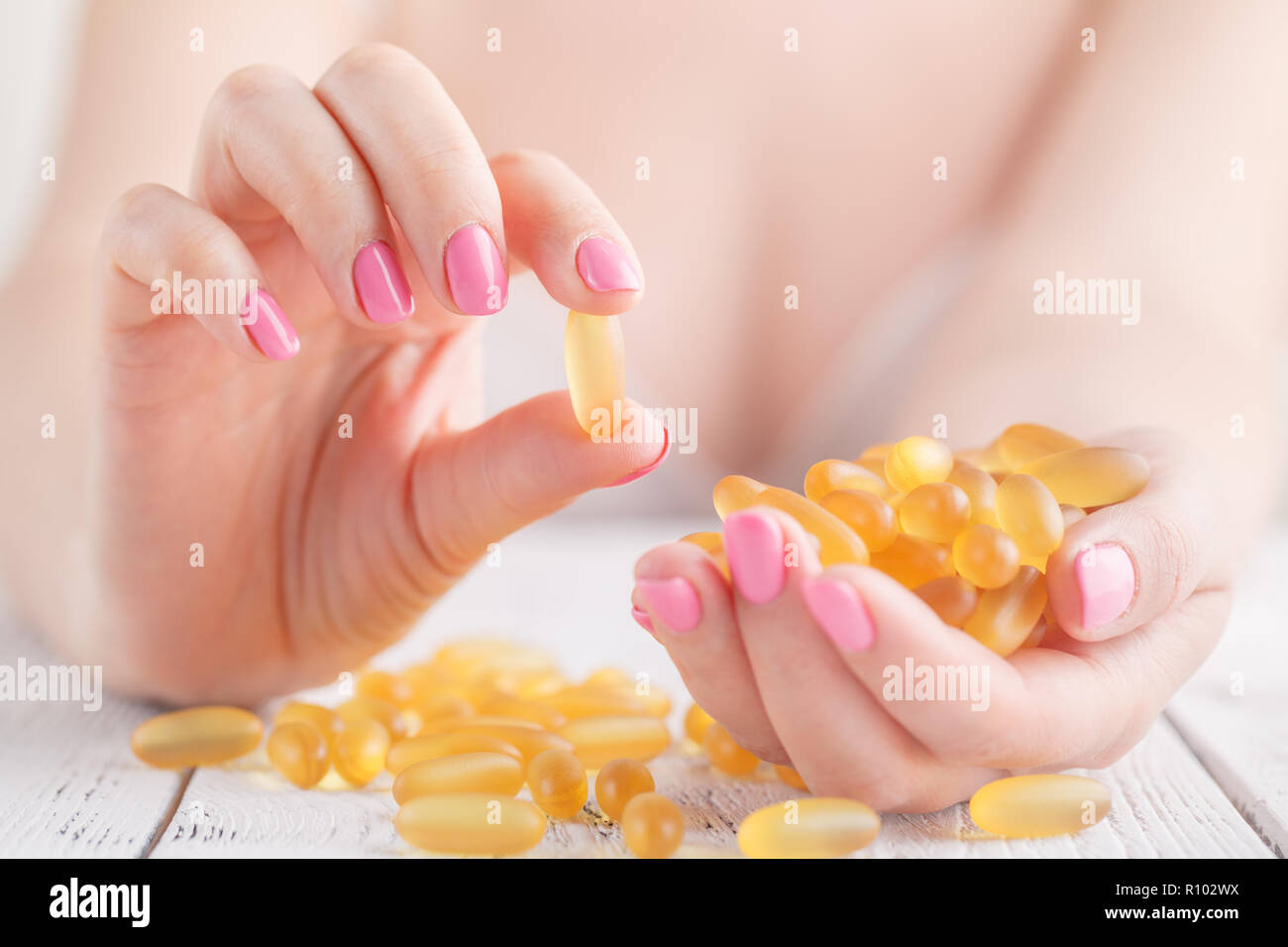 Women holding fish oil hi-res stock photography and images - Alamy