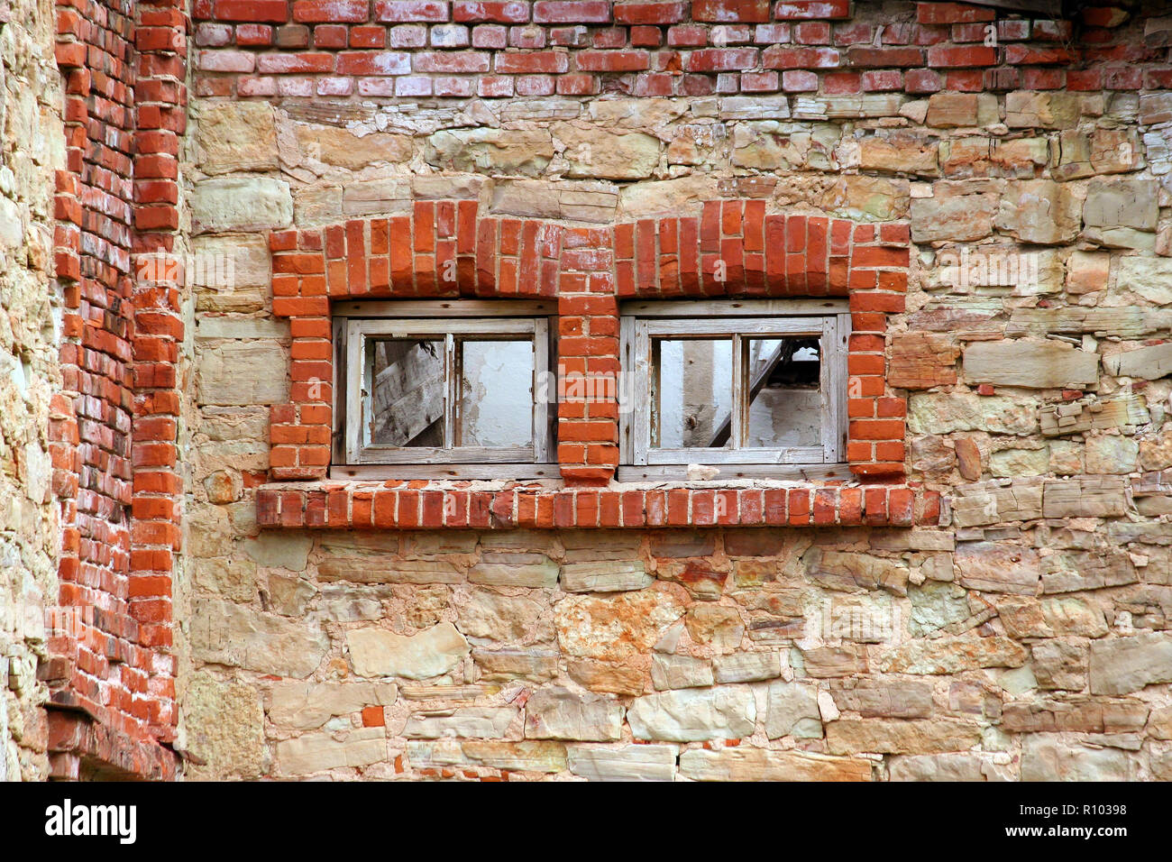 two boarded up windows in an old abandoned building, the windows are ...