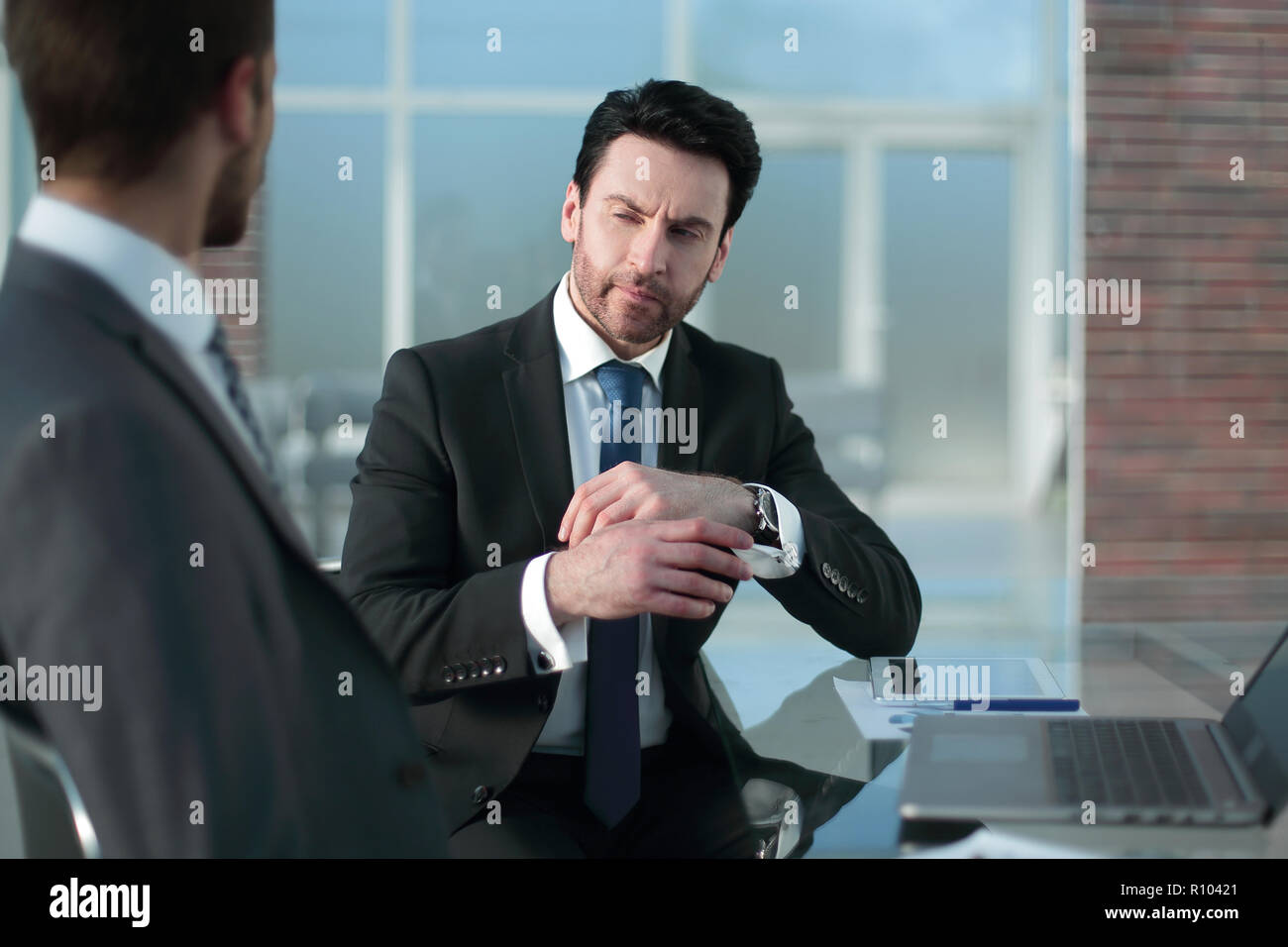 two businessmen sitting at the office table Stock Photo - Alamy