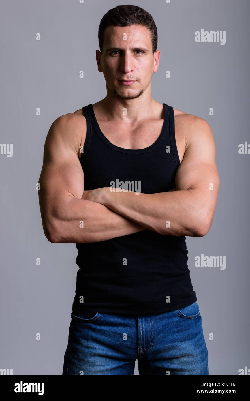 Portrait young man standing arms hi-res stock photography and images ...